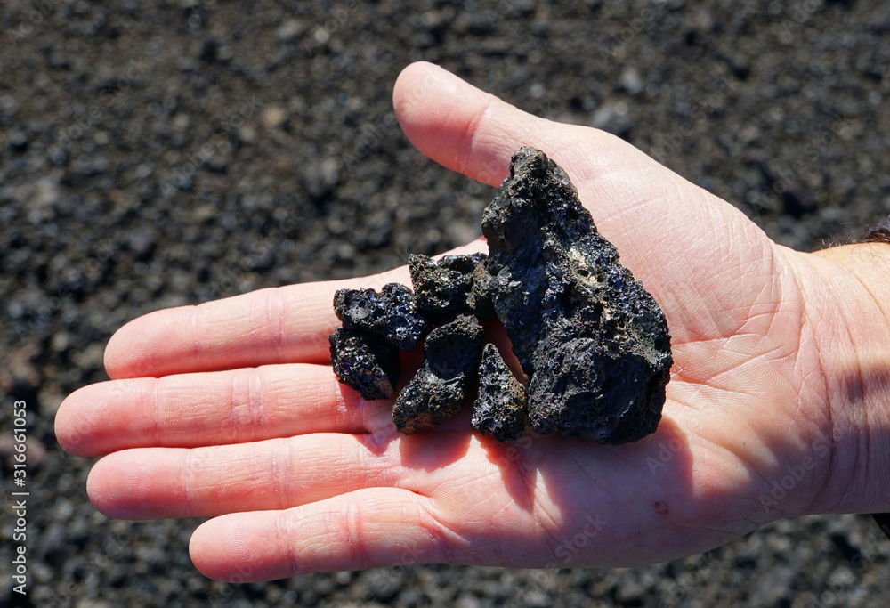 Holding the igneous rock formed from the volcanic eruption at Krafla ...