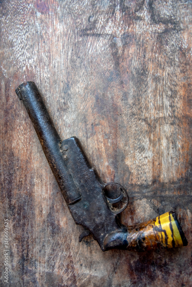 Guns and ammunition placed in a wooden table,Short guns and ammunition ...