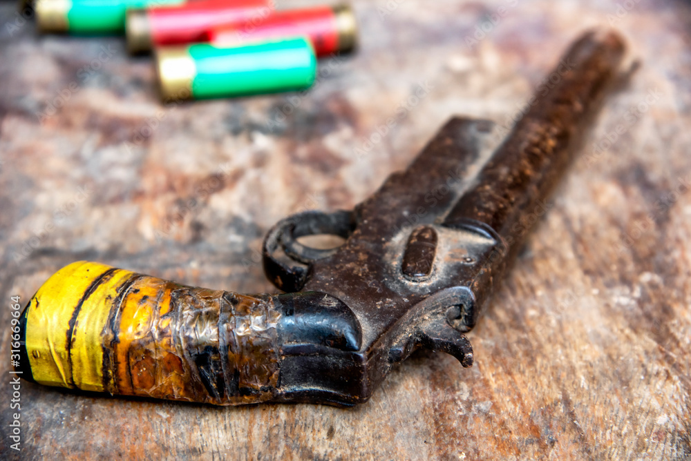 Guns and ammunition placed in a wooden table,Short guns and ammunition ...