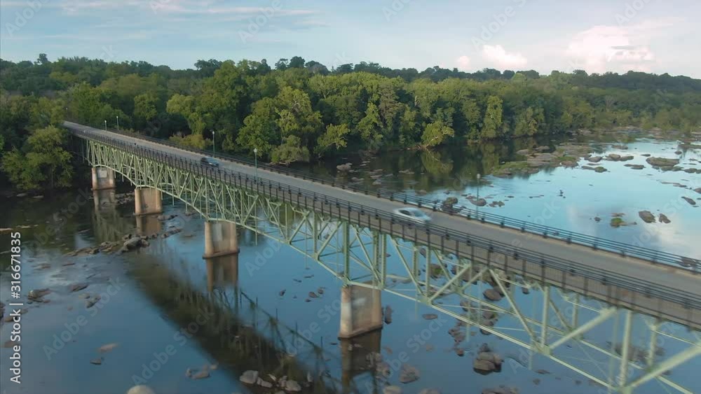 Aerial: Traffic on bridge crossing the James River. Richmond, Virginia ...