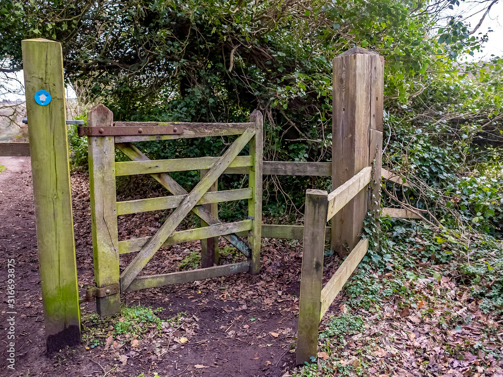 Mouldy green wooden kissing gates on a popular walking path in the ...
