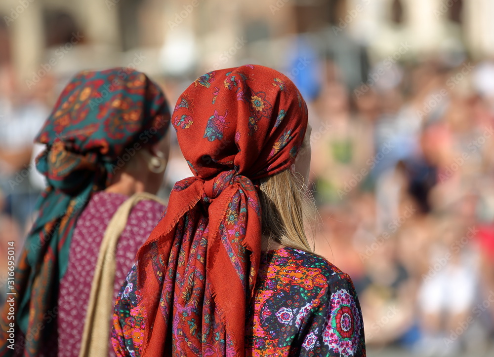 woman in traditional costume, two Gypsies girls on their back, with ...