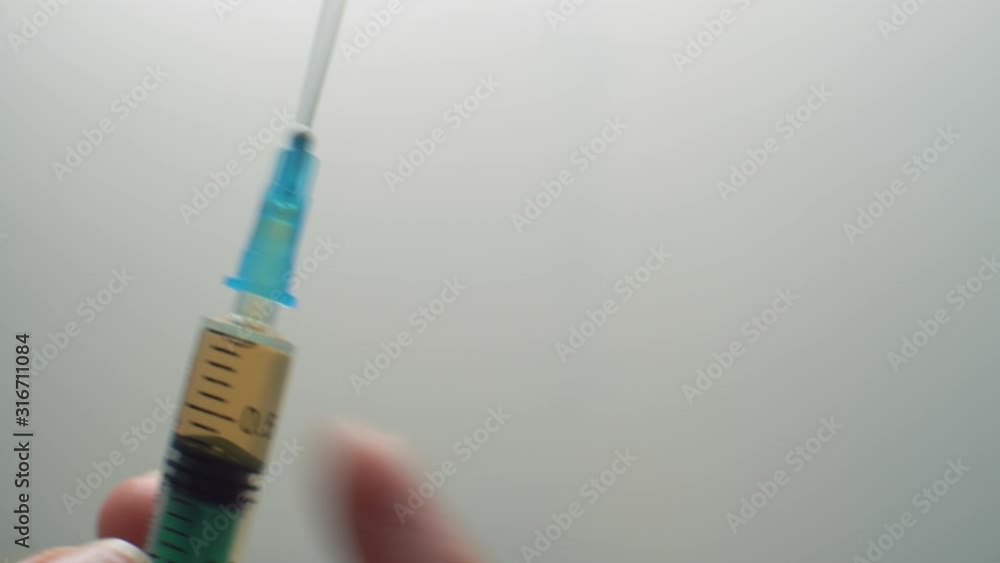 injection shot syringe macro. The doctor bleeds air from a syringe ...