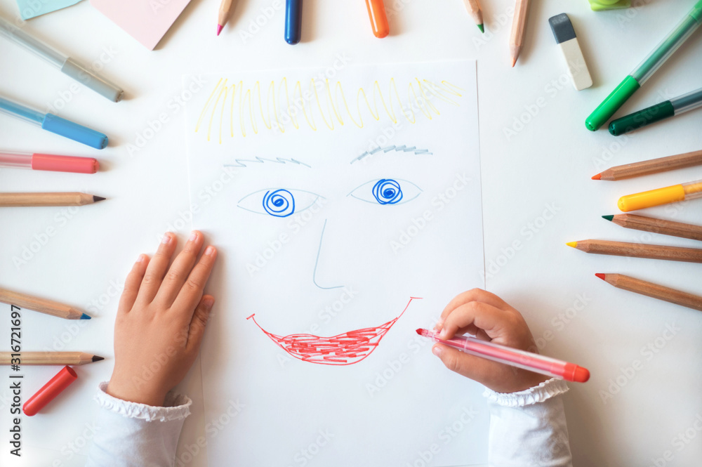 Child's hands drawing happy face on white paper sheet. Close up. Stock ...