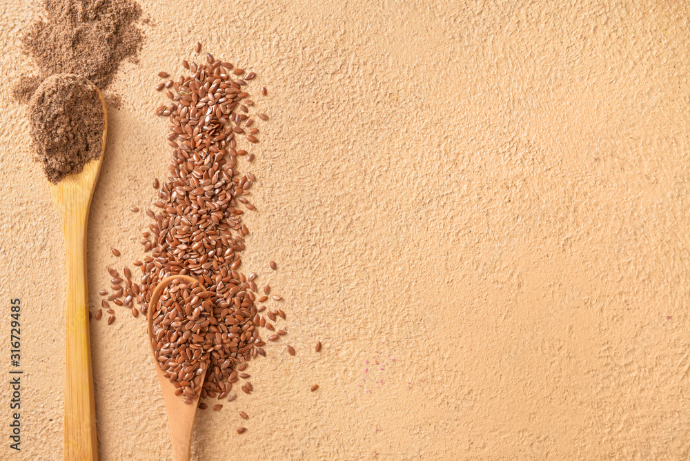 Spoons with flax seeds and powder on color background Stock Photo ...