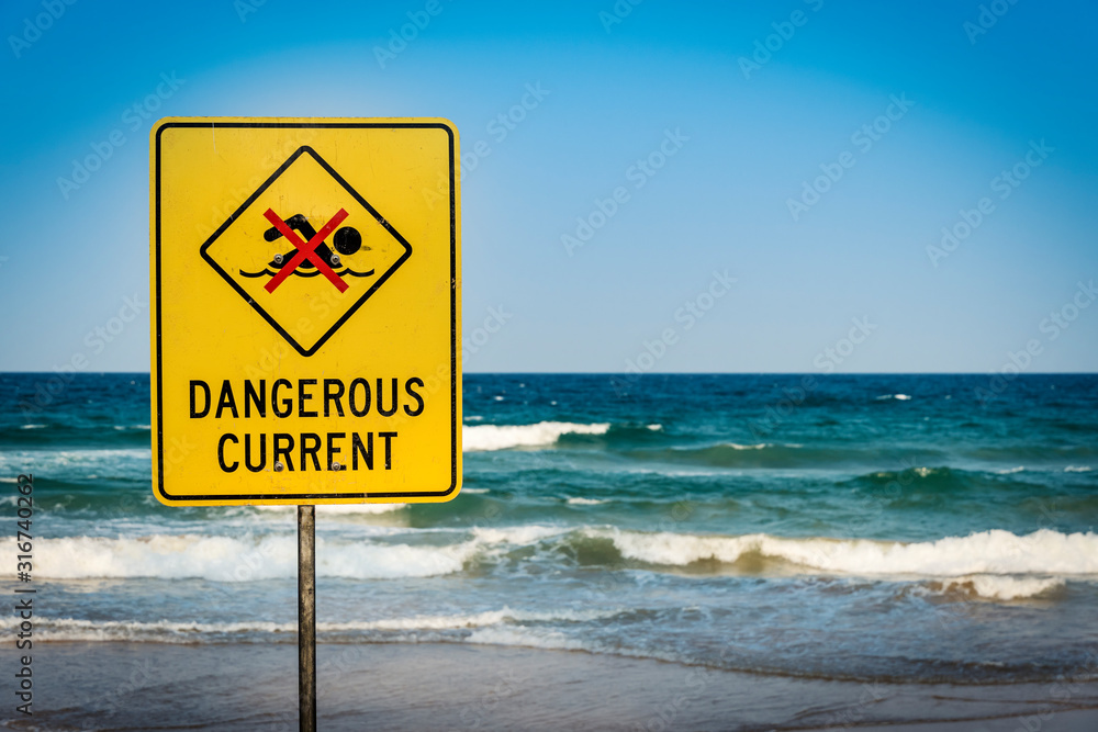 Dangerous current warning sign for swimmers at beach Stock Photo ...