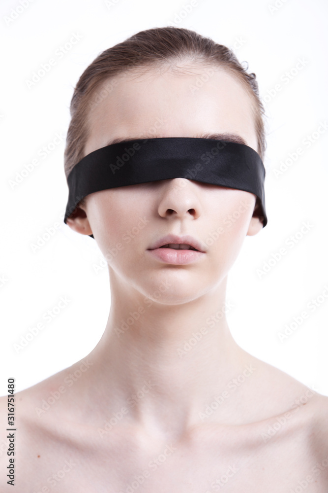 Shirtless young woman blindfolded against white background Stock Photo ...