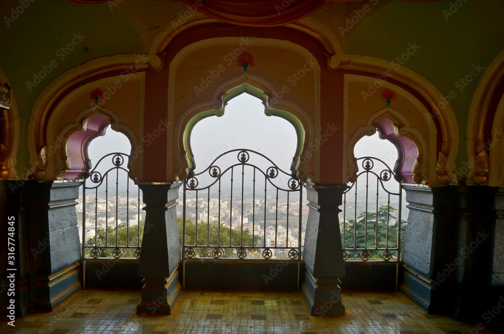 Corridor of an ancient Hindu temple with lightly colored arches. City ...