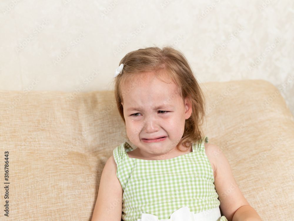 The baby is crying. the child is upset. tears on eyes Stock Photo ...