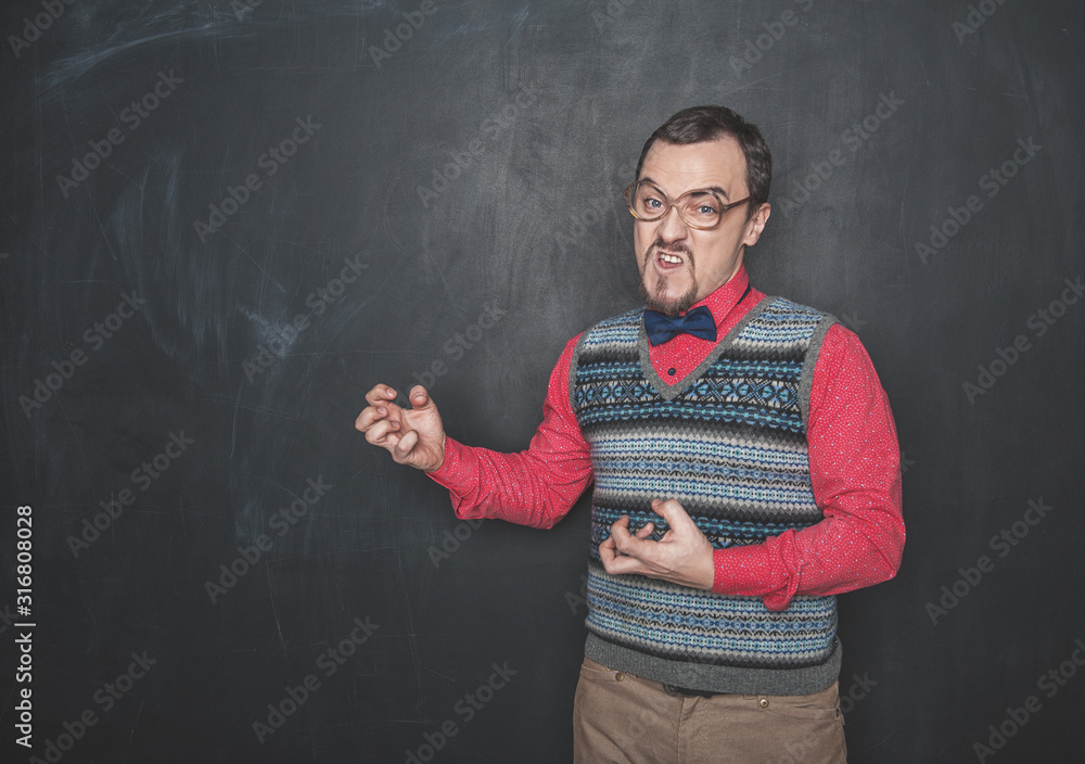 Angry teacher or business man on blackboard background Stock Photo ...