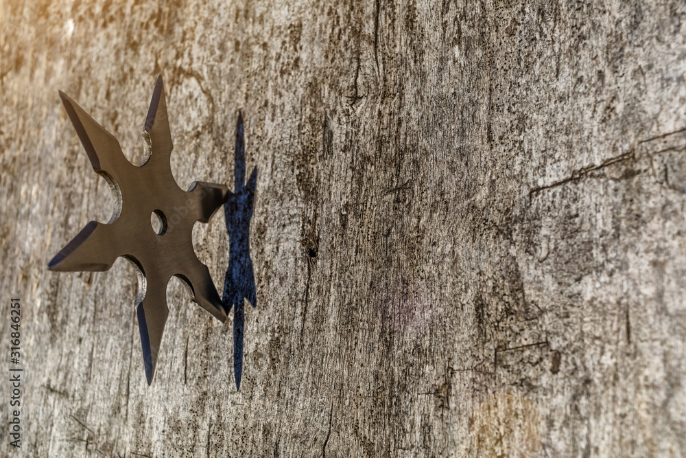 Shuriken (throwing star), traditional japanese ninja cold weapon stuck ...