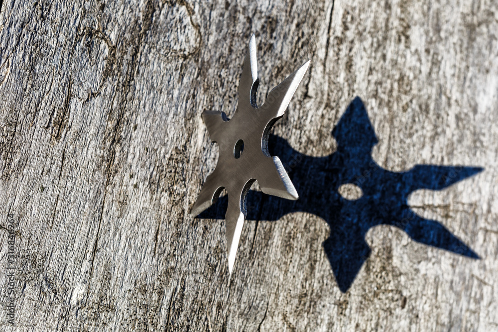 Shuriken (throwing star), traditional japanese ninja cold weapon stuck ...
