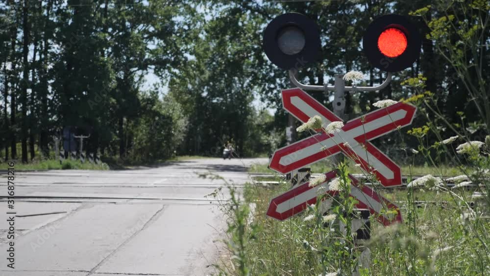 Railway stop sign. Train passing through the crossing. City train rides ...