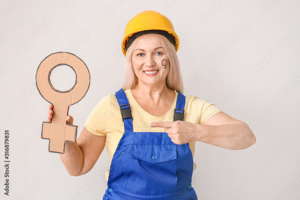 Female worker with symbol of woman on light background. Concept of ...