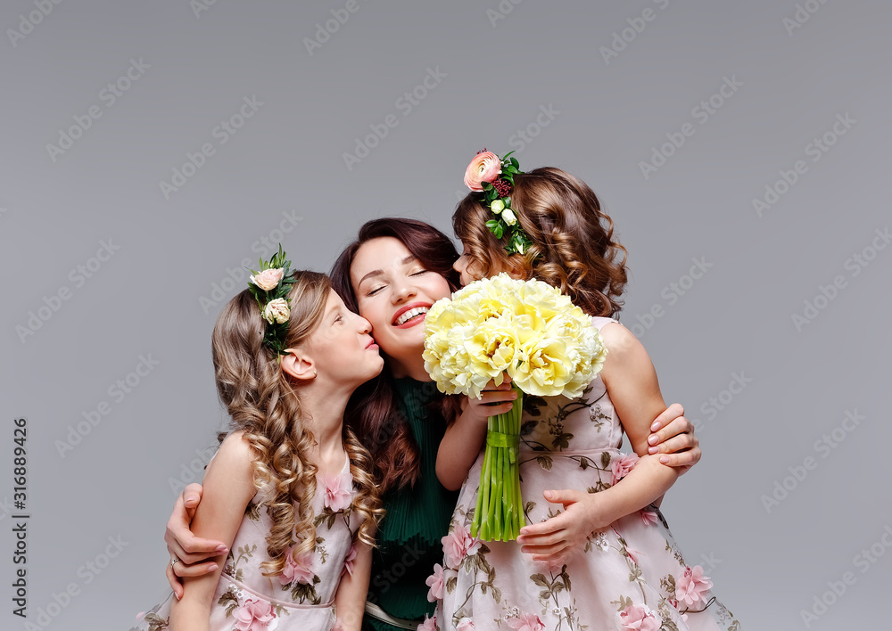 Beautiful happy family mom and two little cute girls in wreaths of ...