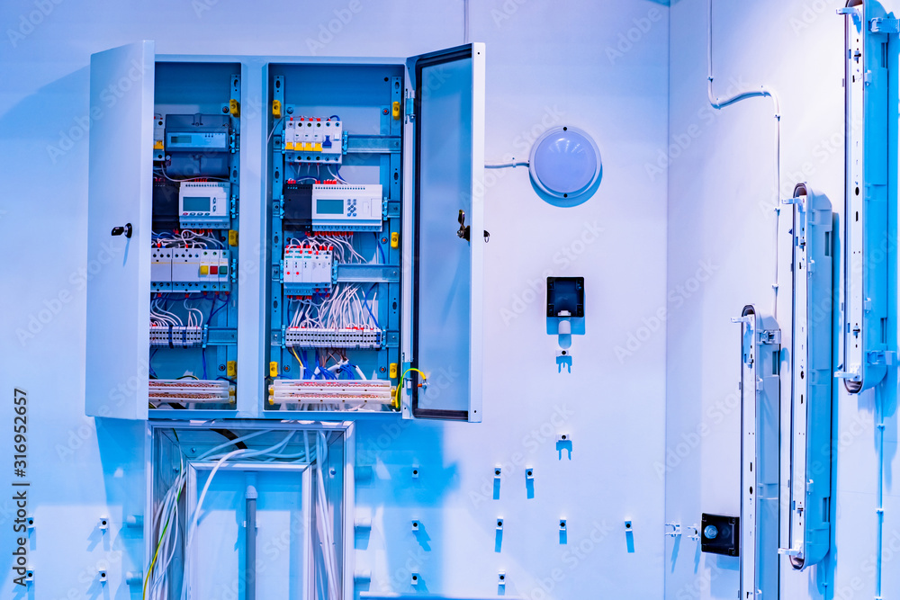 Open electrical cabinet at the enterprise. Utility room. Cabinet with ...
