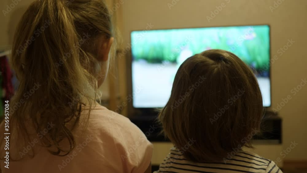 Little Kids While Watching TV. Children Watch Television on Living Room ...