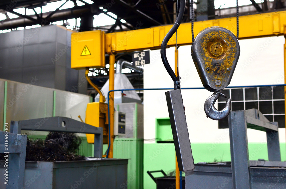Crane hook of the overhead crane in the workshop of an industrial plant ...