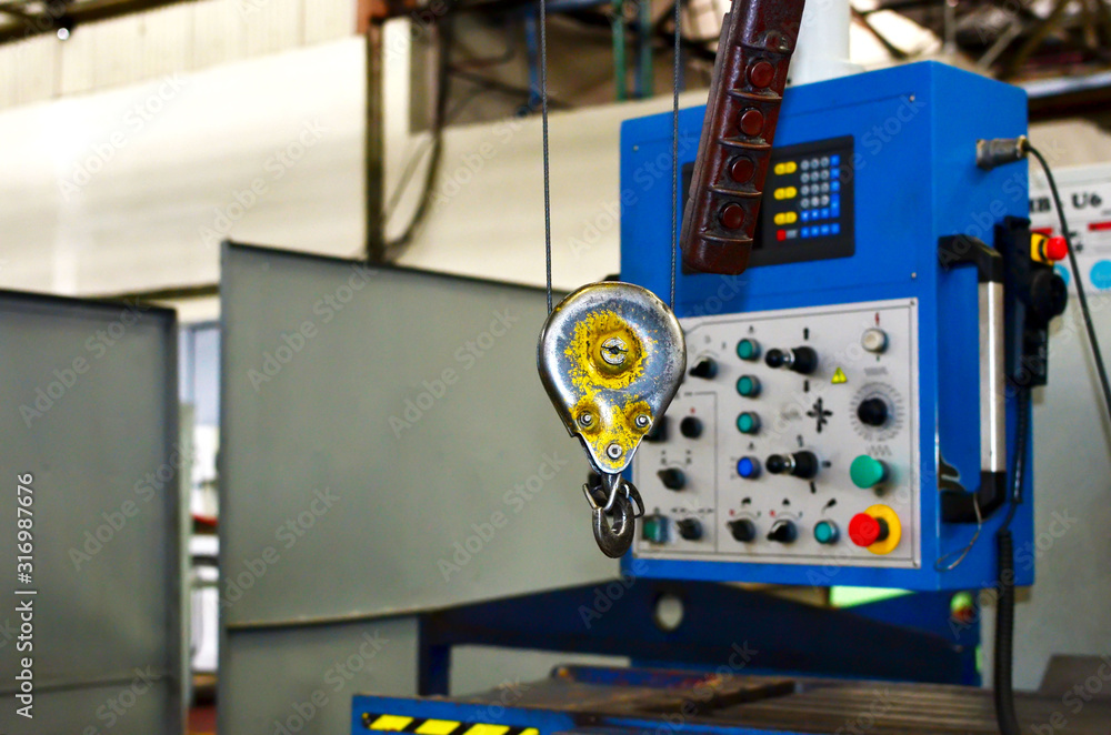 Crane hook of the overhead crane in the workshop of an industrial plant ...