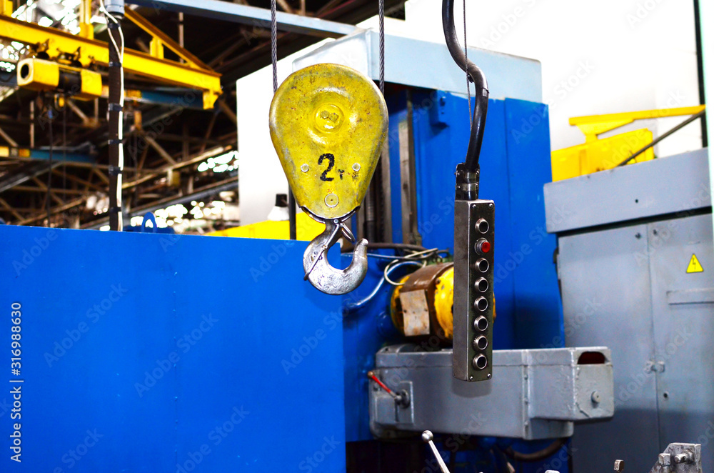 Crane hook of the overhead crane in the workshop of an industrial plant ...