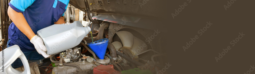 Mechanic adding Engine oil for quality into the engine motor car ...