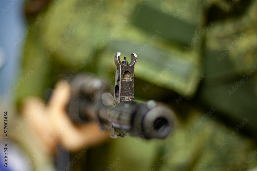 The barrel of an assault rifle. The weapon in the hands. Firearms in ...