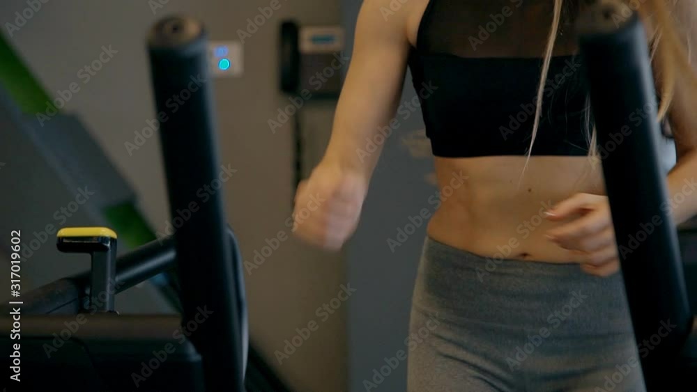 slim woman running on treadmill in gym. Athlete female using run ...