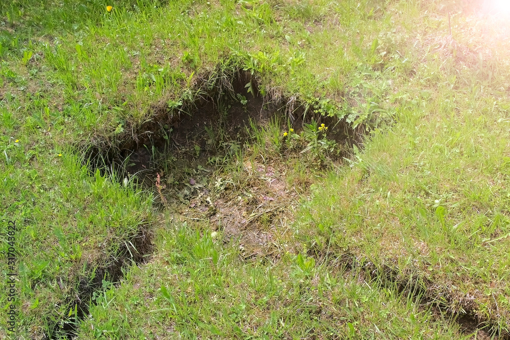 Pits with ditches in the ground to drain water on the plot in the ...