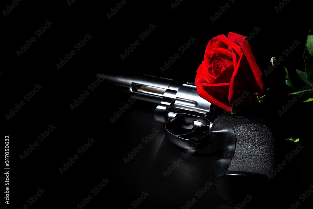roses red and gun on the dark background Stock Photo | Adobe Stock