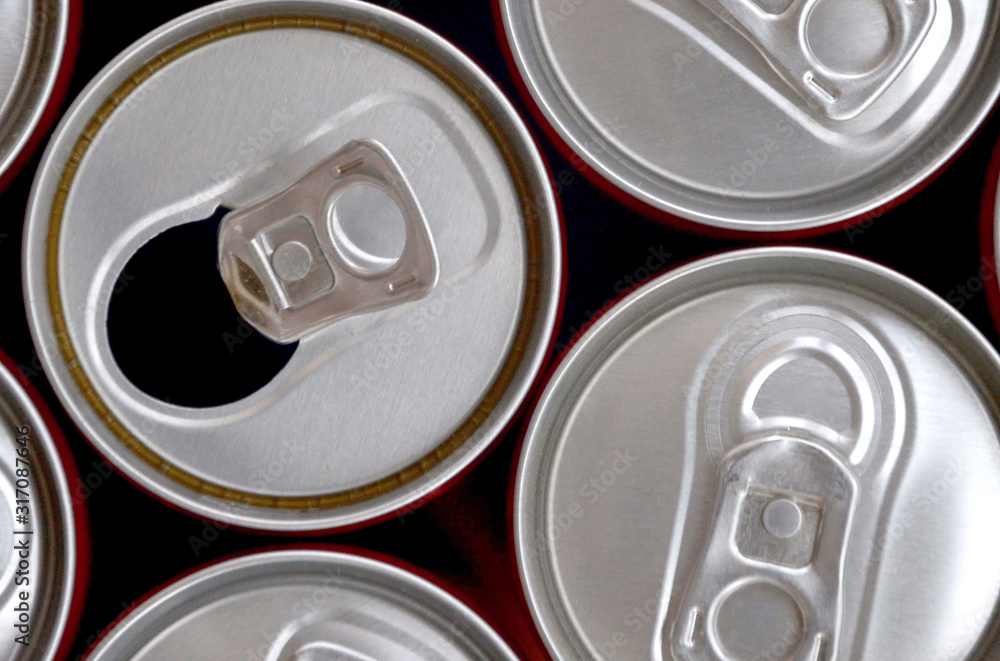 Many cans of soda soft drink or energy drink containers. A lot of ...