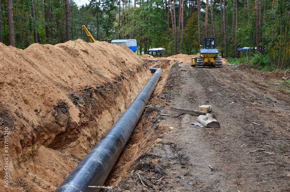 Natural gas pipeline construction work. A dug trench in the ground for ...