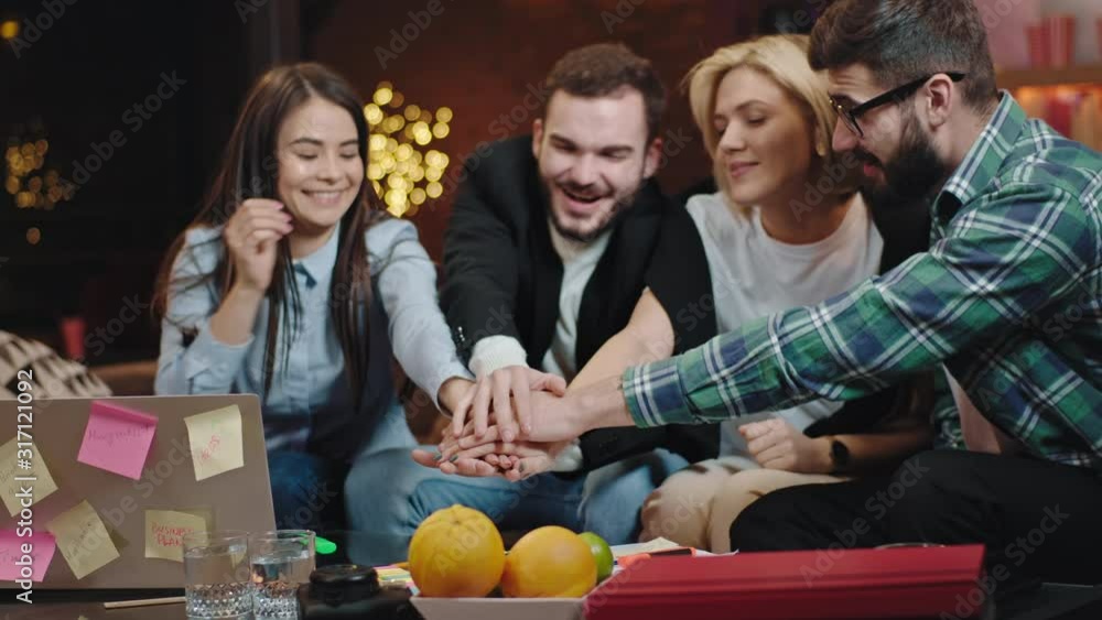 Attractive and smiling large group of office workers doing a plan of ...