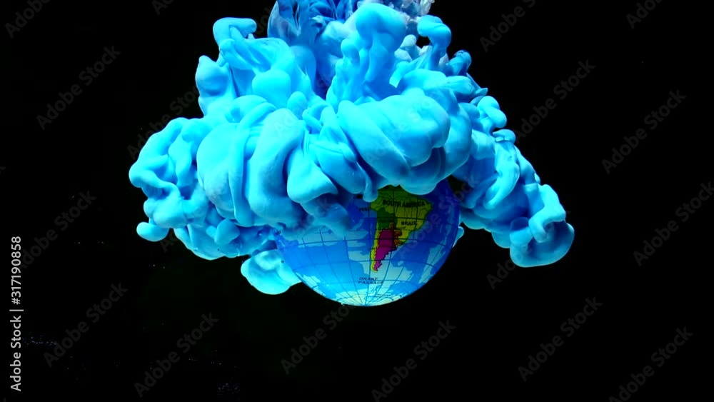 Blue planet earth from space. Blue watercolor ink in water on a black ...