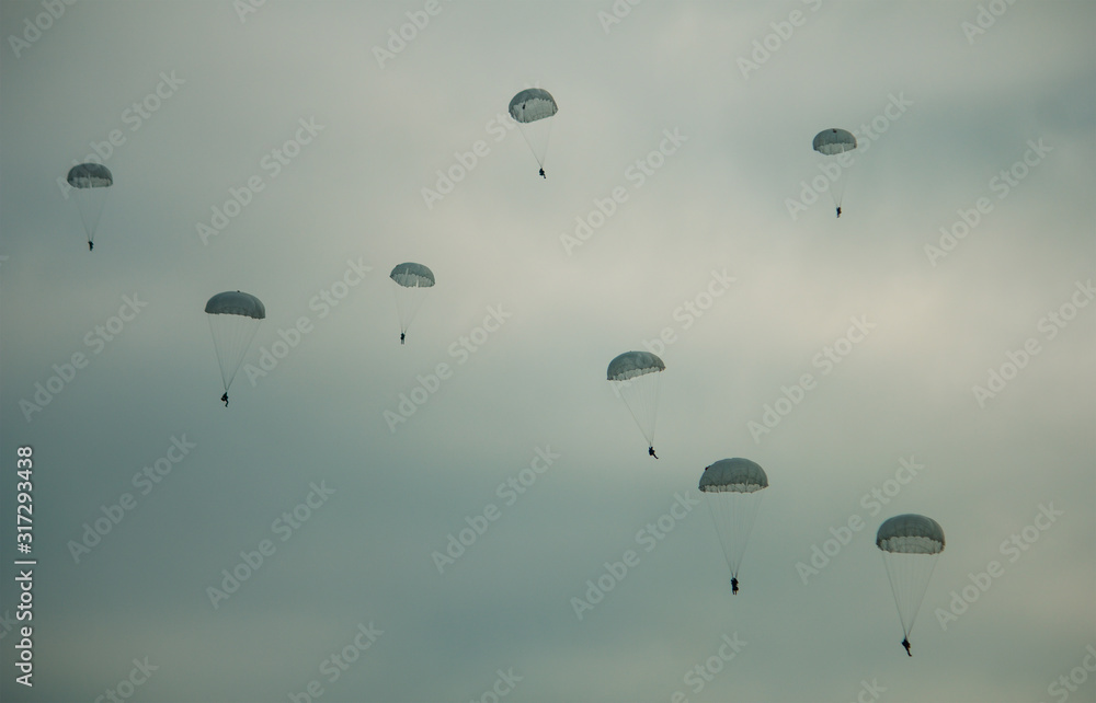 Army paratroopers jumping at air war action. Stock Photo | Adobe Stock