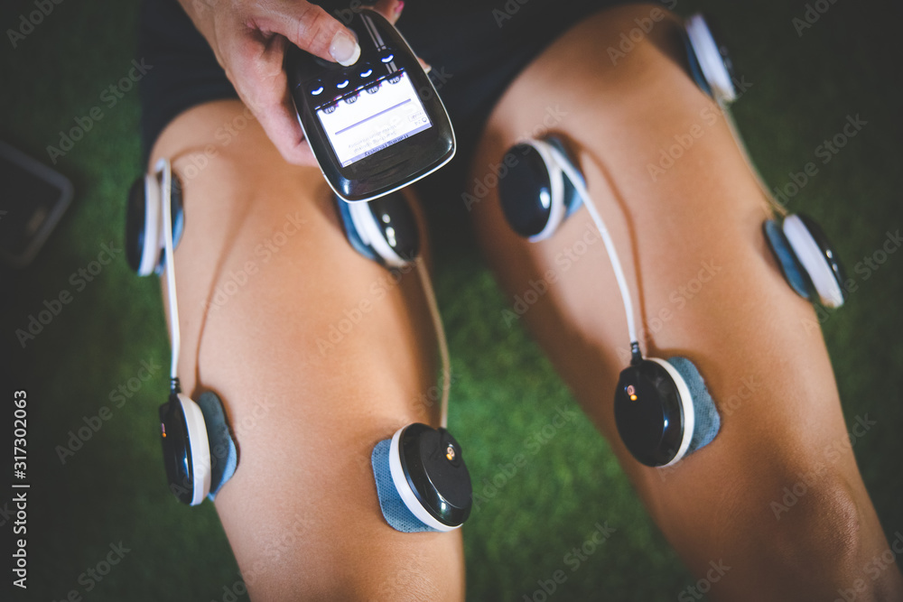 Female fitness model using electronic muscle stimulation technology ...