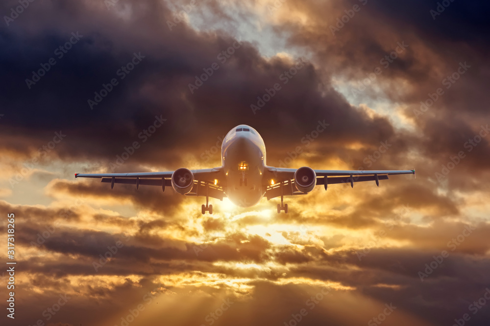 Jet aircraft flying over dramatic sunset dark clouds sky, fastest mode ...