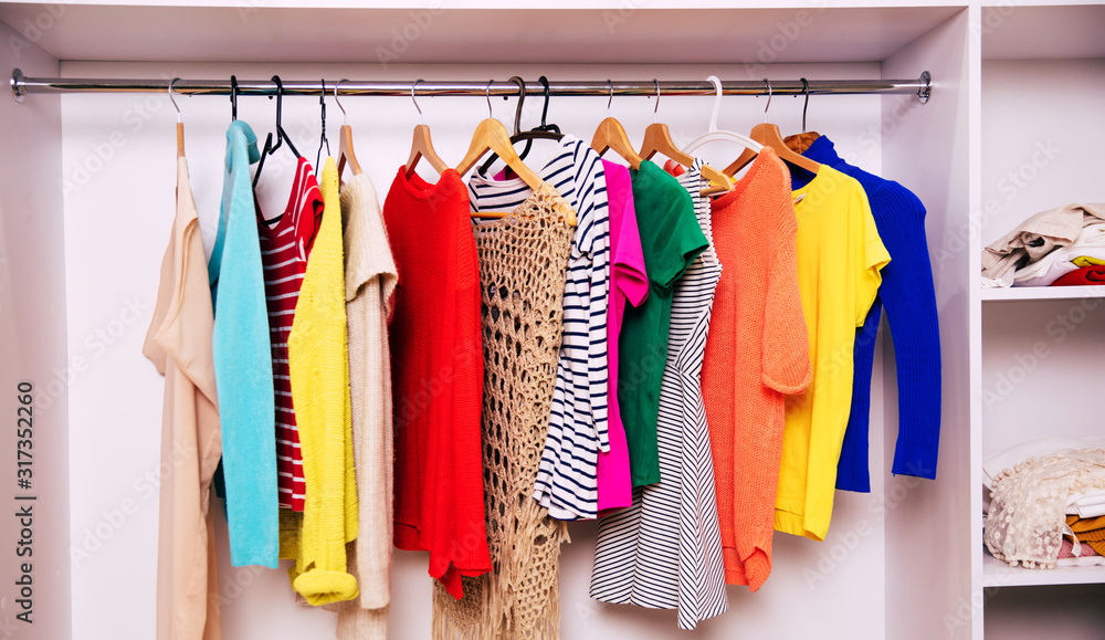 So many clothes. Close-up photo of various pieces of clothes of ...