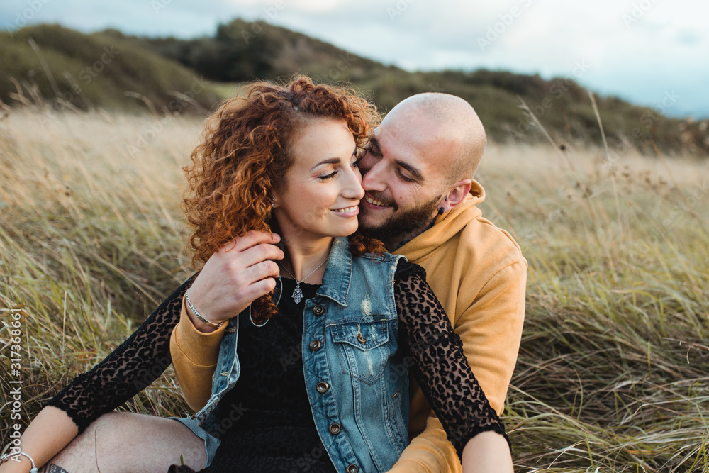 Young bald bearded man in yellow hoodie and jeans shorts embracing ...