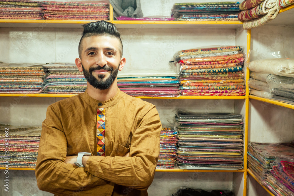 small shop owner indian man selling shawls at his store in arambol goa ...
