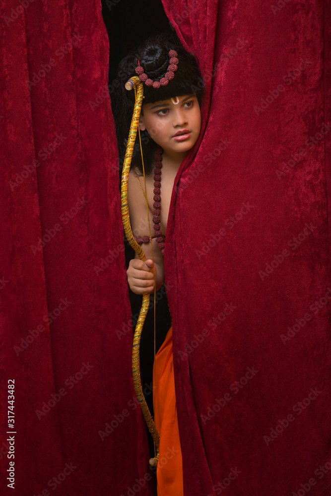 child dressed up as lord ram peeking out of curtains Stock Photo ...