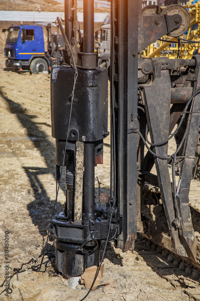 Mobile crane is loading cargo. View on construction site with machinery ...