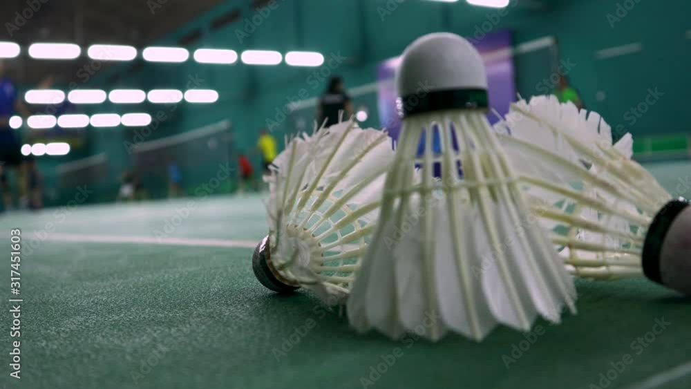 4k bunch of shuttlecock lying on green badminton court, ground and ...