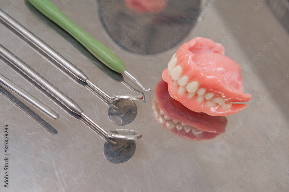 Set of dentures and dental tools. Close up Teeth and dental mirror ...