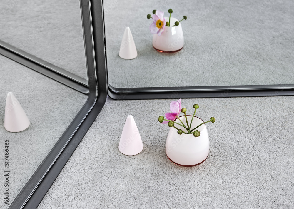Pink cone and vase with Japanese anemone and its reflection in mirror ...