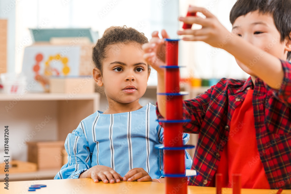 Selective focus of kids playing game during lesson in montessori school ...