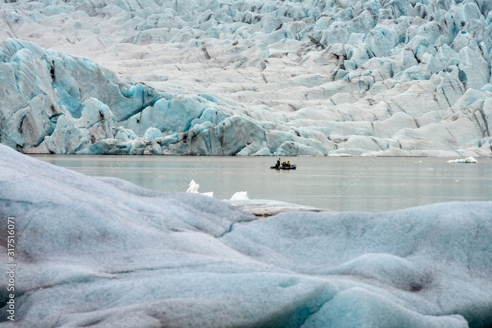 People in little inflatable rubber boat close to Vatnajokull glacier in ...