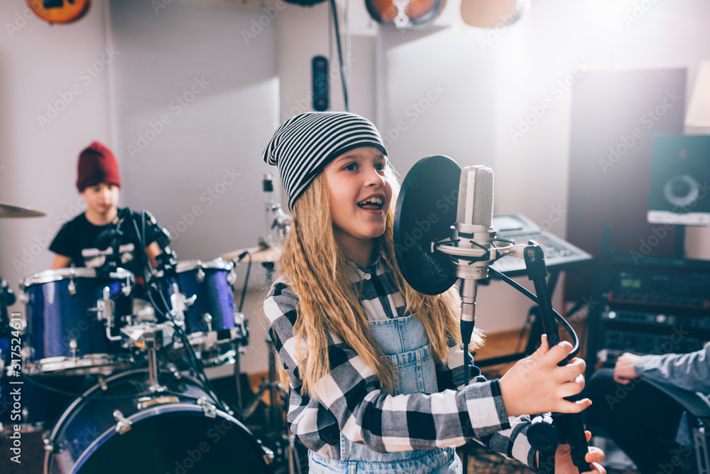 little girl singing in music studio Stock Photo | Adobe Stock
