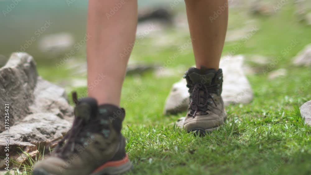 Hiker girl foots in nature with boots. Outdoor woman strolling by the ...