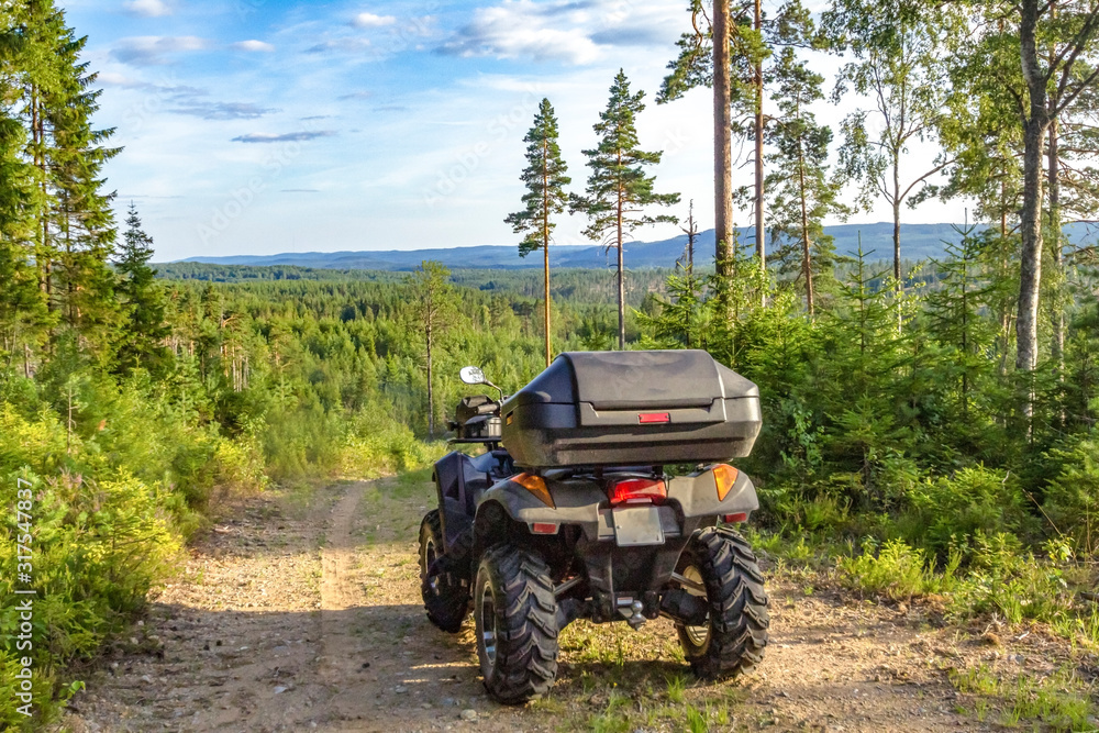 Quad / ATV on a dirt road somewhere in a Swedish forest Stock Photo ...