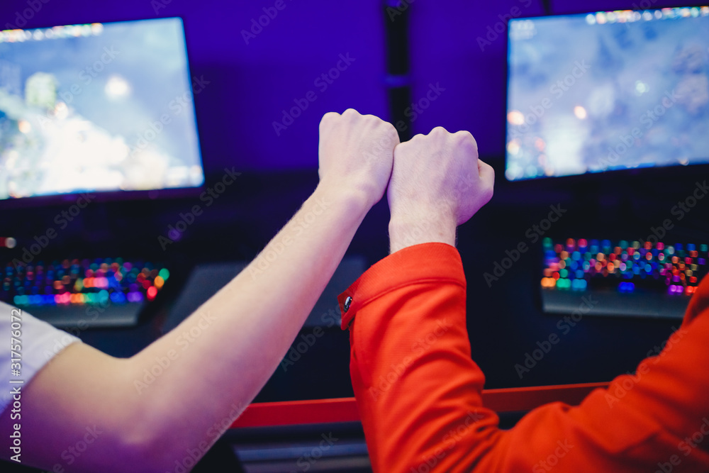 Professional gamer greeting and support team fists hands online game in ...